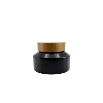 China Black Glass Cosmetic Cream Jar 30ml 50ml Facial Cream Containers With Bamboo Lid for sale