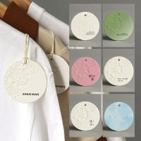 China Custom OEM Embossed Round Clothing Hang Tags with 250gsm-400gsm Premium Textured Art Paper for Fashion Brands for sale