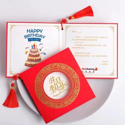 China Custom OEM Luxury Greeting Cards with Hot Foil Stamping Die-Cut Hollow and Handmade Tassel Decoration for sale