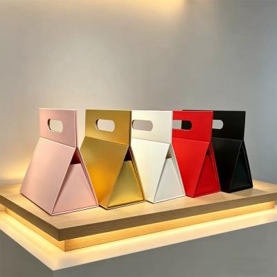 China Triangular Foldable Rigid Gift Boxes With Magnetic Closure And Cutout Handles for sale
