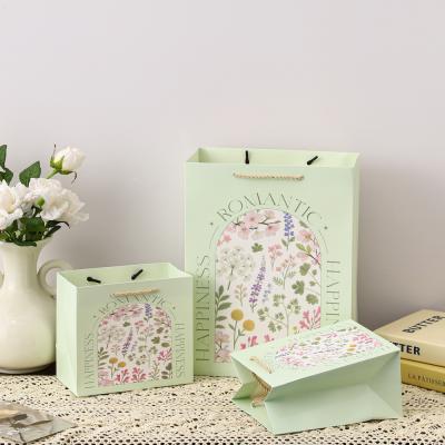 China Floral Printed Paper Gift Bags with Rope Handles for Retail Packaging for sale
