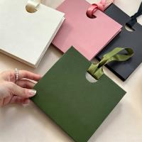 China Ribbon Handle Paper Gift Bags with Die Cut Closure for Retail for sale