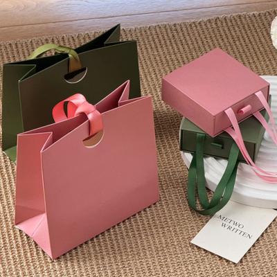 China Ribbon Handle Paper Gift Bags with Die Cut Closure for Retail for sale