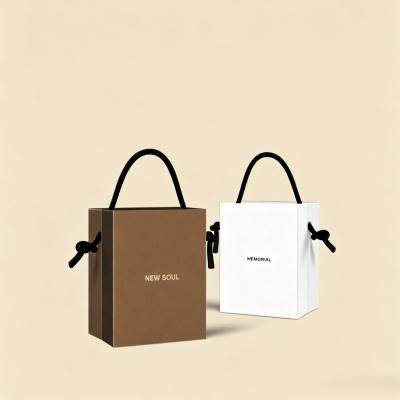 China Handheld Rigid Paper Gift Box with Knotted Rope Handle for Luxury Packaging for sale