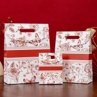China Floral Printed Paper Gift Bags with Die Cut Handle and Flap Top for sale