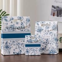 China Floral Printed Paper Gift Bags with Die Cut Handle and Flap Top for sale