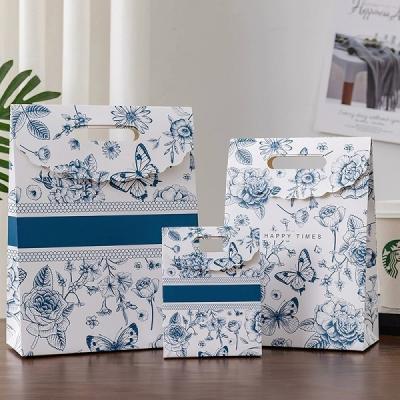 China Floral Printed Paper Gift Bags with Die Cut Handle and Flap Top for sale