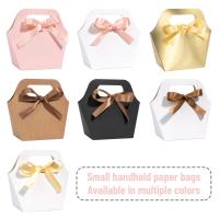 China Paper Gift Bags With Die-Cut Handle And Ribbon Bow For Retail Packaging for sale