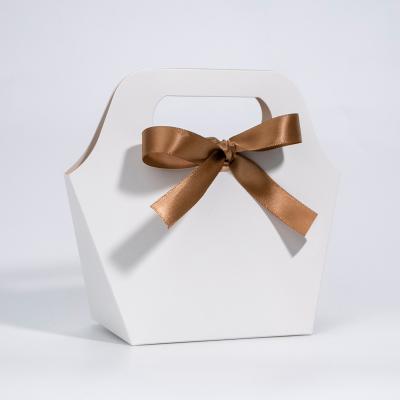 China Paper Gift Bags With Die-Cut Handle And Ribbon Bow For Retail Packaging for sale