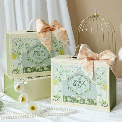 China Luxury Handle Gift Boxes With Ribbon And Floral Pattern For Retail Packaging for sale