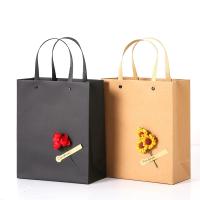 China Kraft Paper Gift Bags With Handle And Decorative Flowers For Retail Packaging for sale