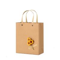 China Kraft Paper Gift Bags With Handle And Decorative Flowers For Retail Packaging for sale