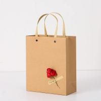 China Kraft Paper Gift Bags With Handle And Decorative Flowers For Retail Packaging for sale