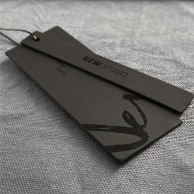 China Multi-Layer Black Paper Hang Tags With Spot UV Finish For Apparel Branding for sale