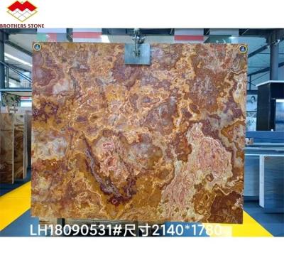 China Polished Translucent Natural Tiger Red Onyx Marble for Modern Backlit Jade Hotel Design for sale