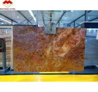 China Polished Translucent Natural Tiger Red Onyx Marble for Modern Backlit Jade Hotel Design for sale