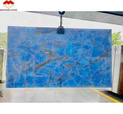 China Natural Translucent Blue Onyx Stone Slab for TV Background Wall Panel in Golden Blue for sale