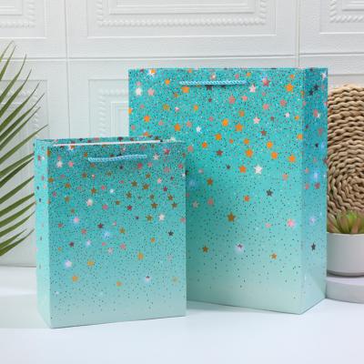 China Bronzing Stars Pattern Paper Bag With Starwing Handle Blight Colors for sale