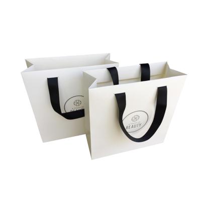 China Luxury White Gift Paper Bag Custom Made Printed Logo Jewelry Packaging Shopping Bag for sale