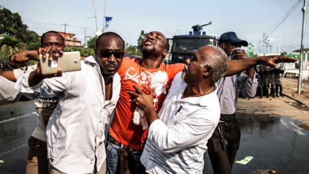 A Ping supporter is carried away during clashes with police