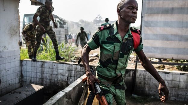 A Gabonese soldier runs to take position as supporters of opposition leader Jean Ping protest