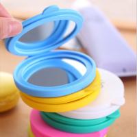 China Modern Round Silicone Glass Cosmetic Double Side Fold Portable Makeup Pocket Mirror for sale