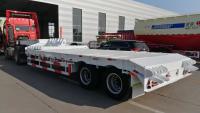 China Sinotruk HOWO 3axle 60t Semi Lowbed Trailer with Ramp 7000-8000mm Wheel Base Flatbed for sale