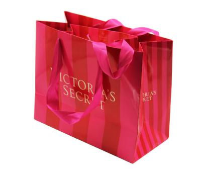 China custom printed striped paper shopping bags manufacturer with handle for sale