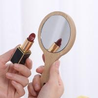 China Hand-held wooden beauty mirror portable handle dressing mirror home bathroom round small mirror for sale