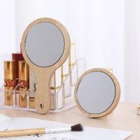 China Hand-held wooden beauty mirror portable handle dressing mirror home bathroom round small mirror for sale