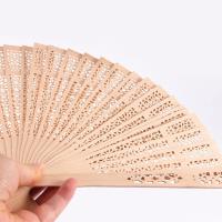 China Custom Chinese Carved Folding Fragrance Wood Hand Fan Hotel Wedding Fan for sale
