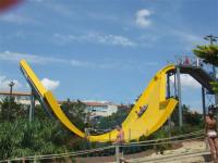 China Banana Shape Water Park Slide Multicolour 12 Meters Pendulum Water Slide for sale