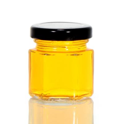 China Round Transparent 100ml Glass Jars for Honey Storage Food Packaging with Metal Lids for sale