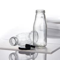 China Bpa Free 25Oz 32Oz Pasterurization Juice Milk Delivery Glass Bottle With Metal Lid for sale