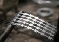 China Flat Razor Galvanized Barbed Wire Razor Fence Roll PVC Coated 26mm~100mm Barb Distance for sale