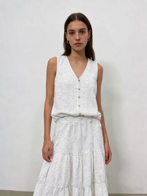 China Elegant White Two-piece Set with Textured Floral Embroidery V-neck Sleeveless Top and Tiered Flowy Maxi Skirt for sale