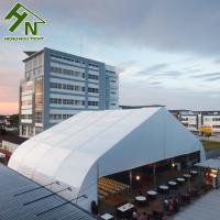 China 30x100m Curved Event Tent TFS Sandwich Panel Wall Giant Exhibition Hall for sale