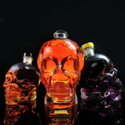 China Customize Skull Shape Hot Stamping Screen Printing 750ml Glass Liquor Bottle with Lid for sale