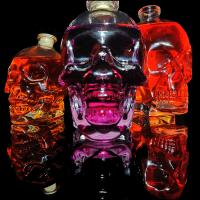 China Customize Skull Shape Hot Stamping Screen Printing 750ml Glass Liquor Bottle with Lid for sale