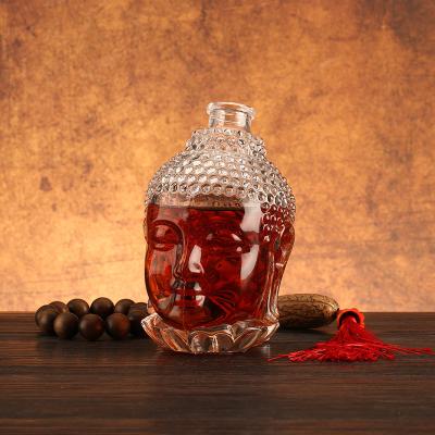 China Unique Buddha Head Shaped Glass Bottles with Aluminum Plastic PP Collar Material for sale