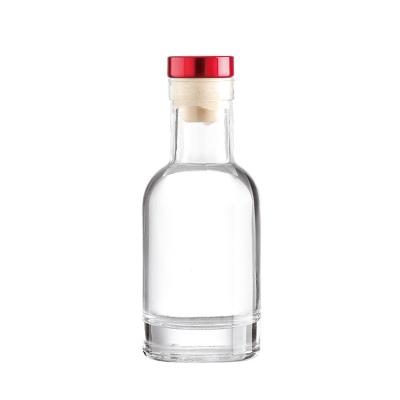 China 100ml 200ml Clear Round Shape Liquor Gin Vodka Bottle with Super Flint Glass Body Material for sale