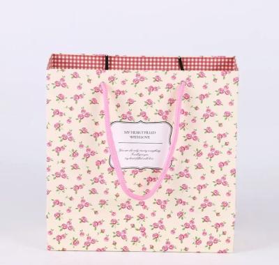 China Custom Luxury Gift Garment Paper Shopping Bags With Logo Print for sale