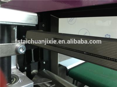 China Automatic Feeding System nipple Packing Machine masks packaging machine horizontal packing machine for sale