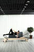 China Adjustable Maple Wood Pilates Reformer U+PL001G with Ergonomic Carriage for sale