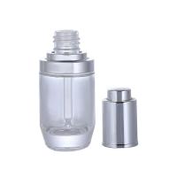 China Round Transparent Glass Foundation Bottle Simple Design Silk Screen Printing Cosmetic Packaging for sale