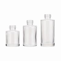 China Simple Round Glass Foundation Bottle with Free Samples Transparent Glossy Finish for sale