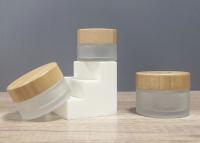 China JiaZi Frosted Clear Glass Cosmetic Jar Wood Grain Lids 50g Bamboo Cream Jar for sale