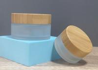 China JiaZi Frosted Clear Glass Cosmetic Jar Wood Grain Lids 50g Bamboo Cream Jar for sale