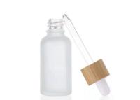 China Empty Essential Oil Bamboo Cap 30ml Glass Dropper Bottle Transparent Frosted for sale