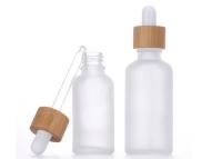 China Empty Essential Oil Bamboo Cap 30ml Glass Dropper Bottle Transparent Frosted for sale